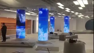 A cylindrical LED display with wraparound lighting reshapes the spatial atmosphere, showcasing high-