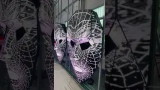 The unique design of the mask-shaped LED screen showcases high-definition images.