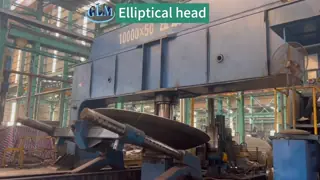 Elliptical heads are pressed using a drum press machine.