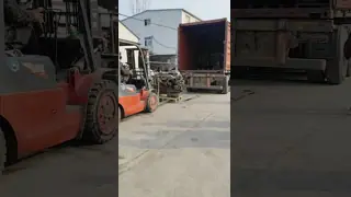Loading used engines into containers.