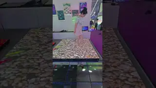 An interactive floor display panel integrated into the interior, featuring a sensor chip.