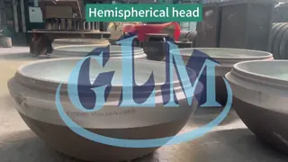 stacked hemispherical pressure‑vessel heads waiting for final inspection