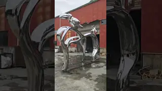 This sculpture makes an abstract tree body suit for entrance for amusement parks