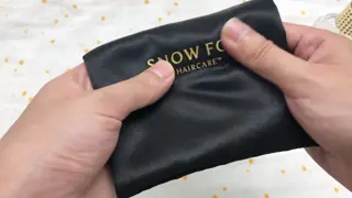 black matte satin drawstring pouch with label