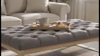 Why are upholstered coffee tables becoming more popular in modern living rooms?