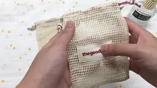 white cotton mesh drawstring pouch with fabric label