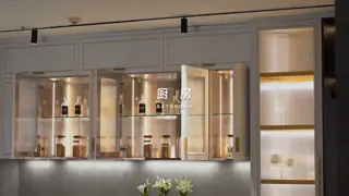 modern grey brass - trimmed kitchen cabinets - island - glass storage